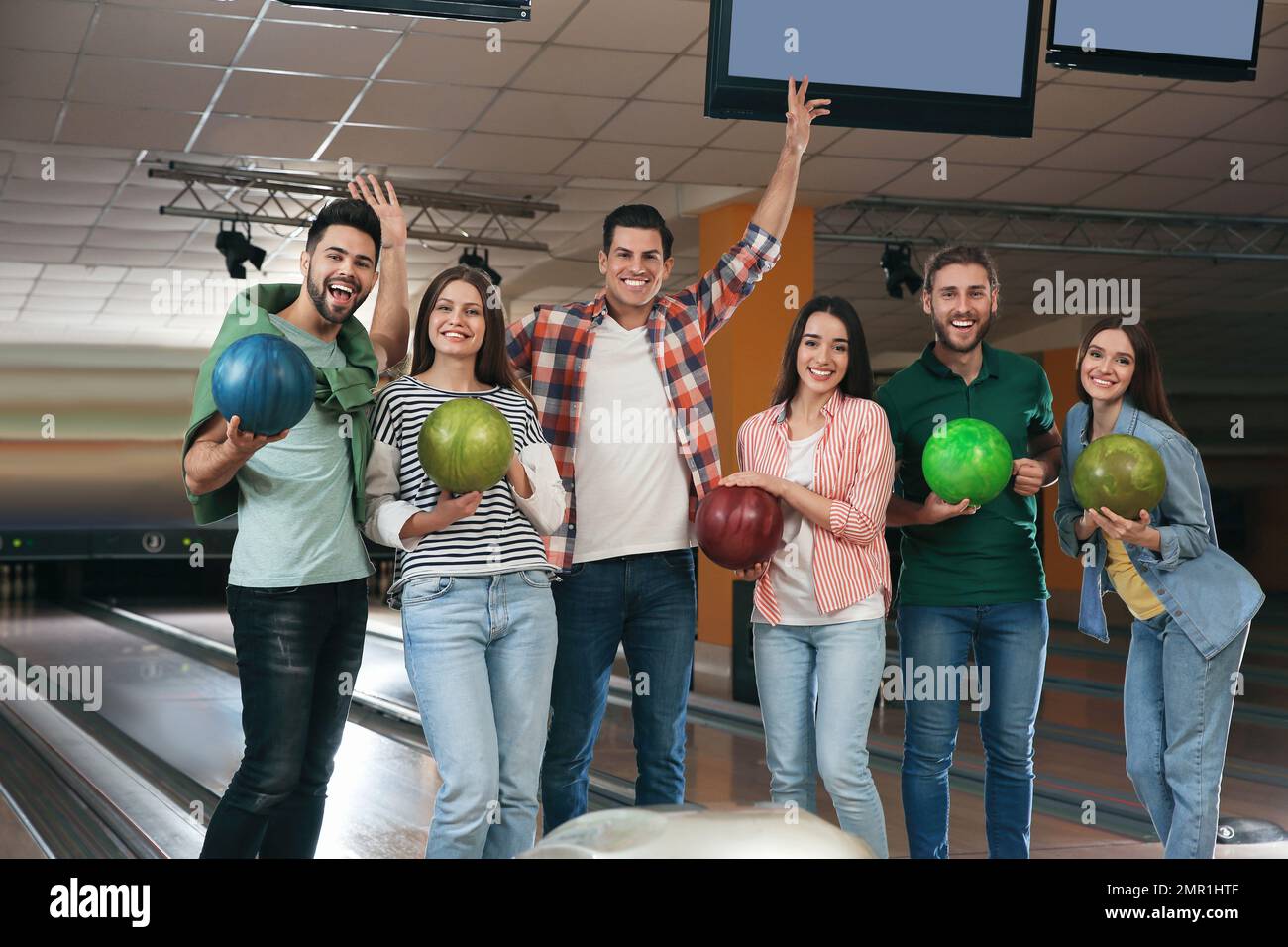 Group of friends with balls in bowling club Stock Photo - Alamy