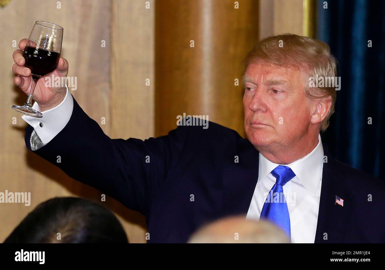 U.S. President Donald Trump raises his glass for a toast during a state ...