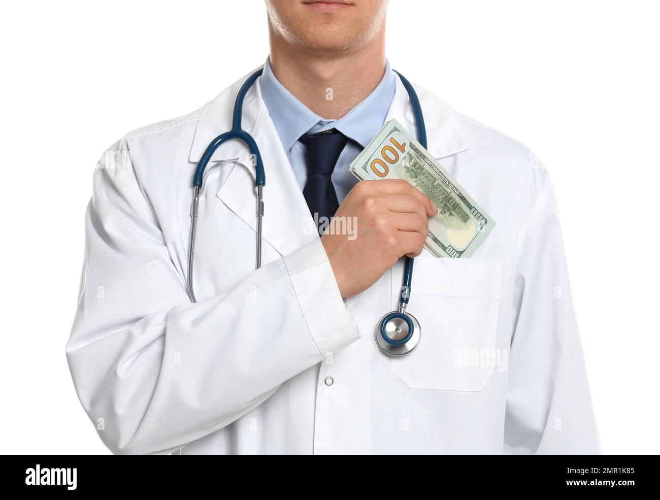 Doctor putting bribe into pocket on white background, closeup ...