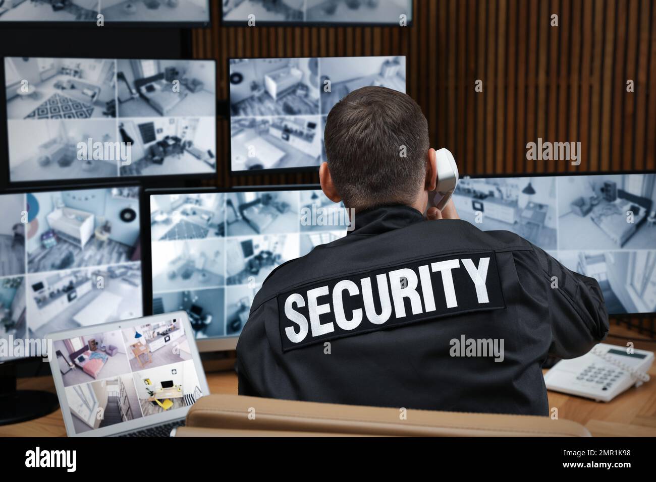 Security guard talking on telephone at workplace Stock Photo - Alamy