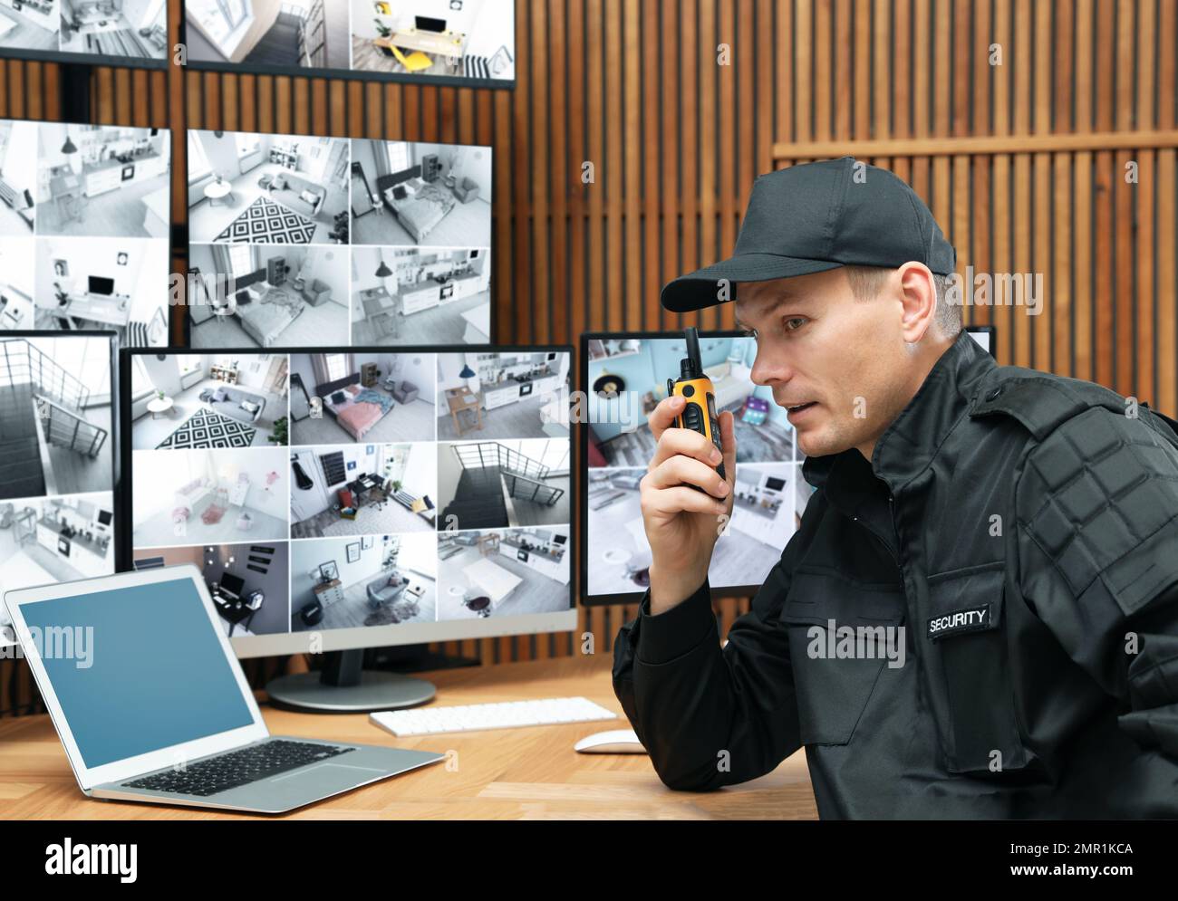 Security guard using portable transmitter at workplace in office Stock ...