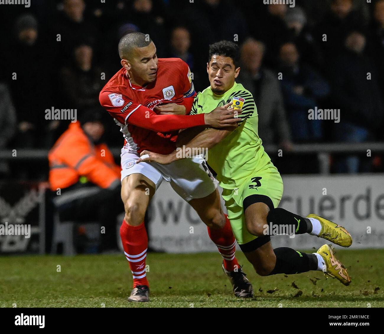 Kyle Knoyle #3 of Stockport County is tackled by Rod McDonald #5 of ...