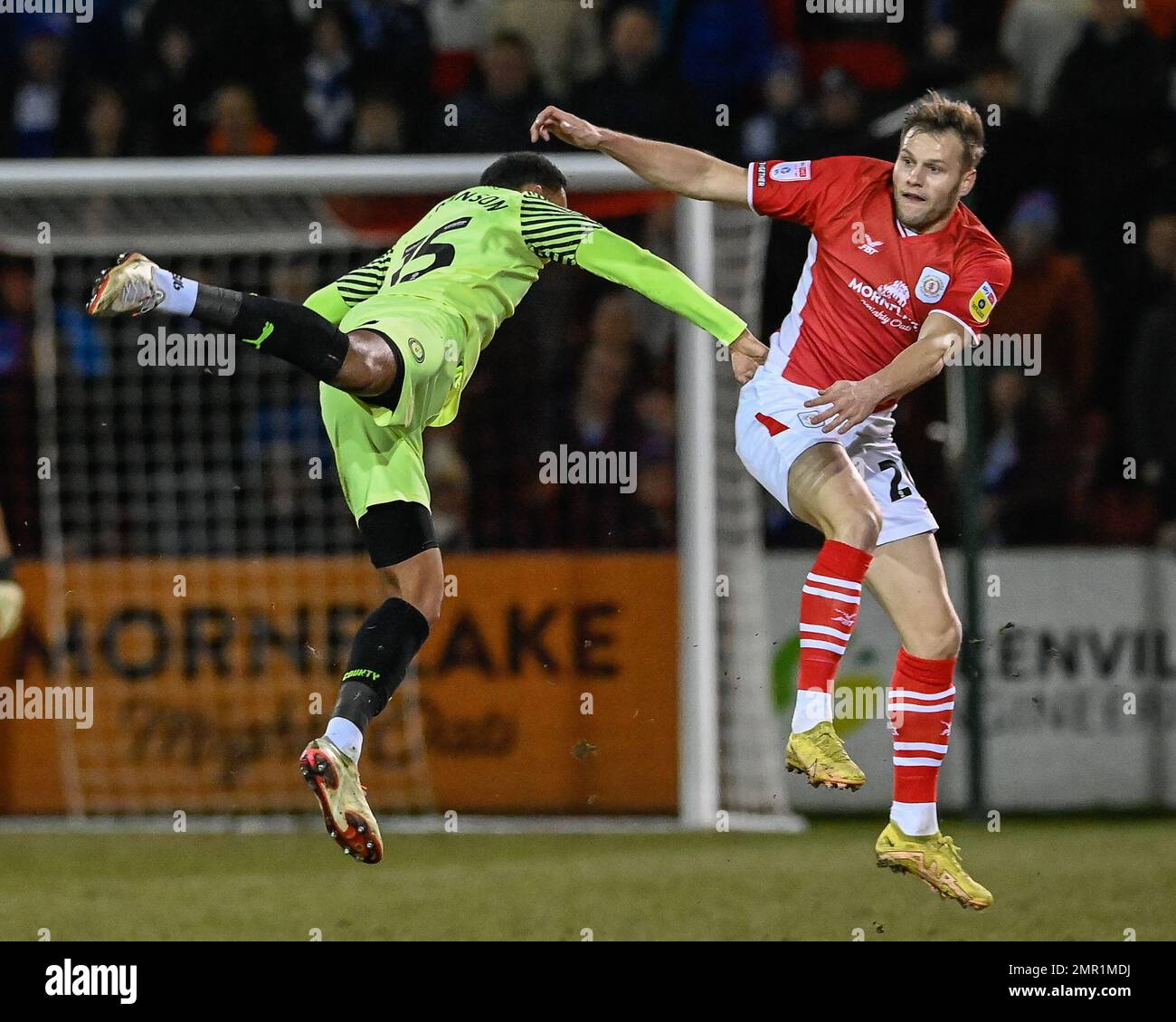 Ryan Johnson #15 of Stockport County is fouled by Elliott Nevitt #20 of ...
