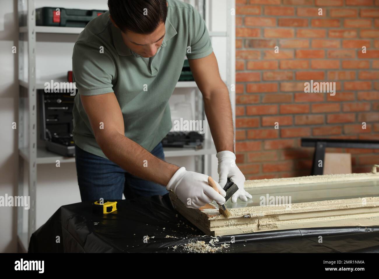 Man repairing old damaged window at table indoors Stock Photo - Alamy