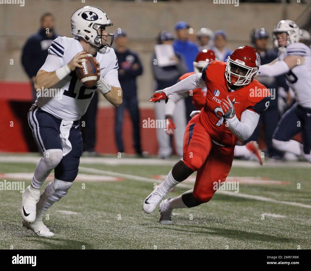 BYU's Tanner Mangum tries to complete a pass as Fresno State's Jeffrey ...