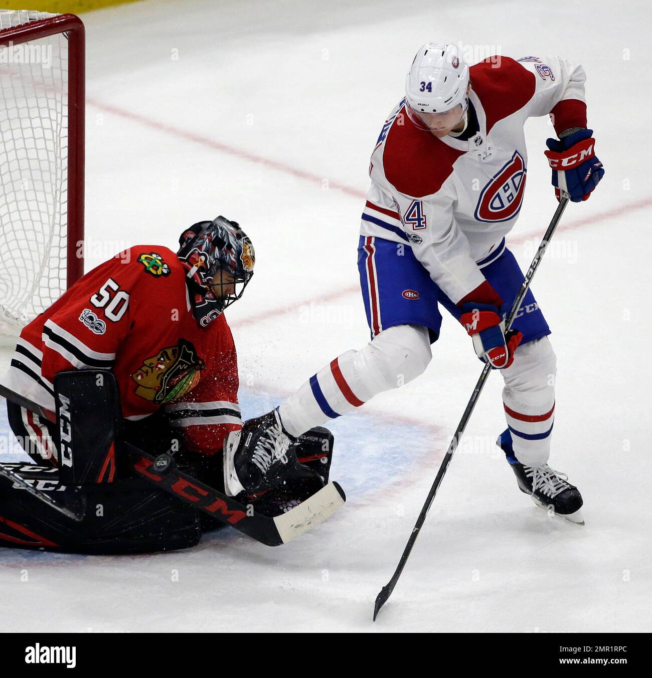 Chicago Blackhawks goalie Corey Crawford, left, blocks a shot by ...