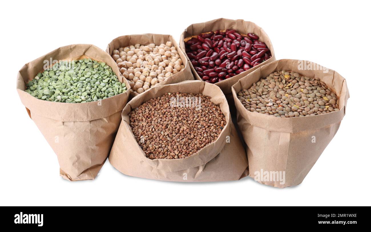 Different types of legumes and cereals in paper bags on white ...