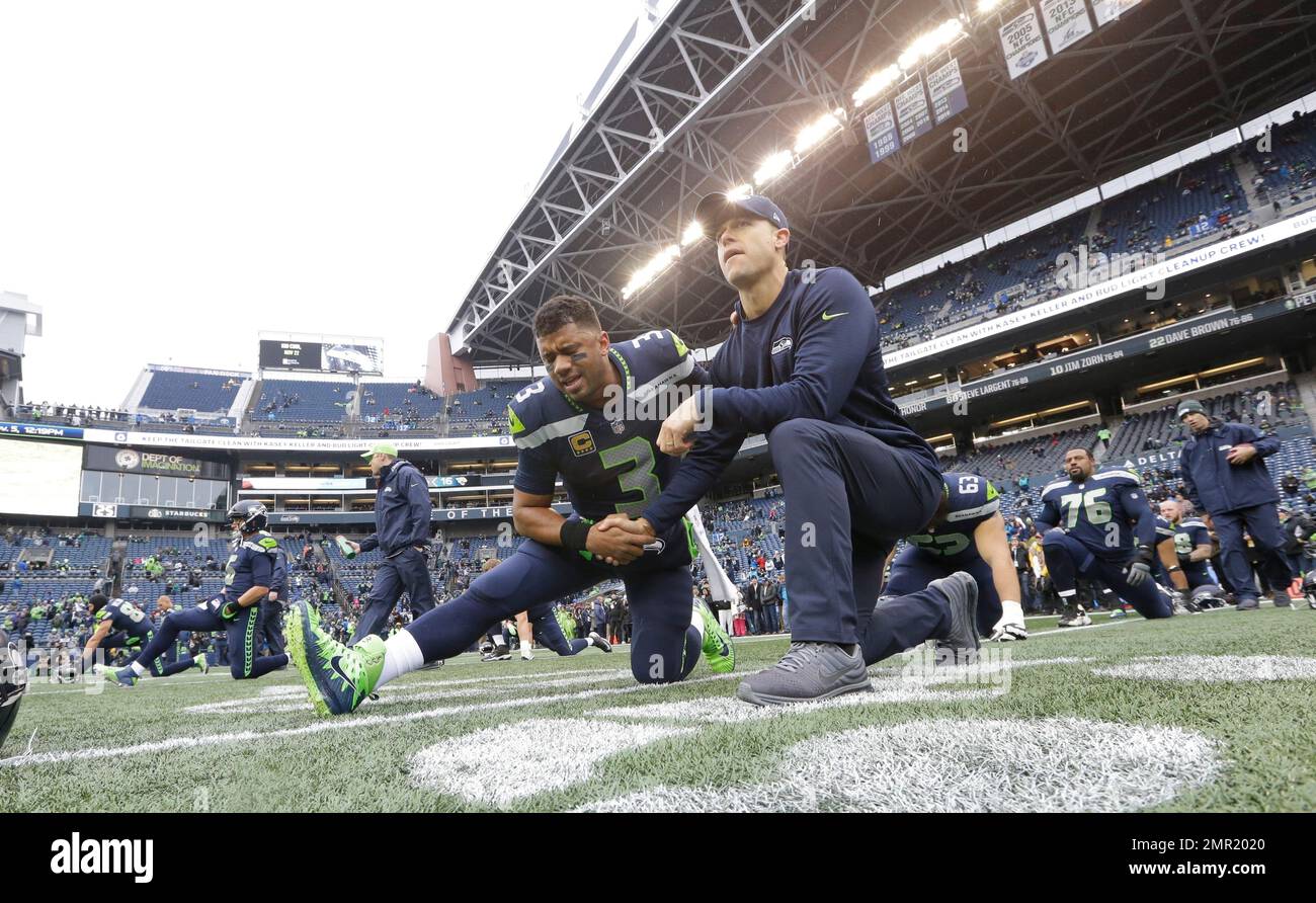 Seattle Seahawks quarterback Russell Wilson, left, prays with wide ...