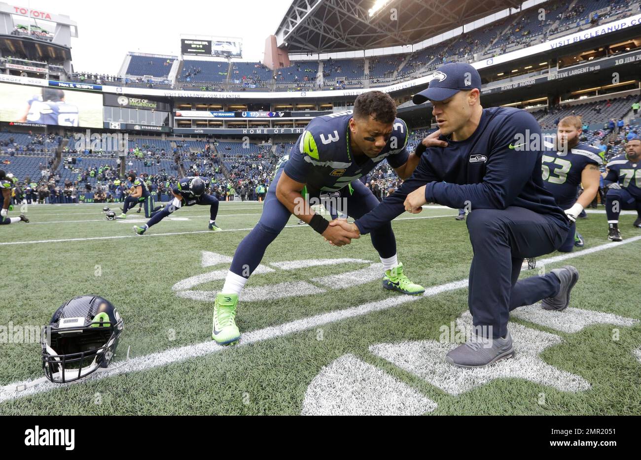 Seattle Seahawks quarterback Russell Wilson, left, prays with wide ...