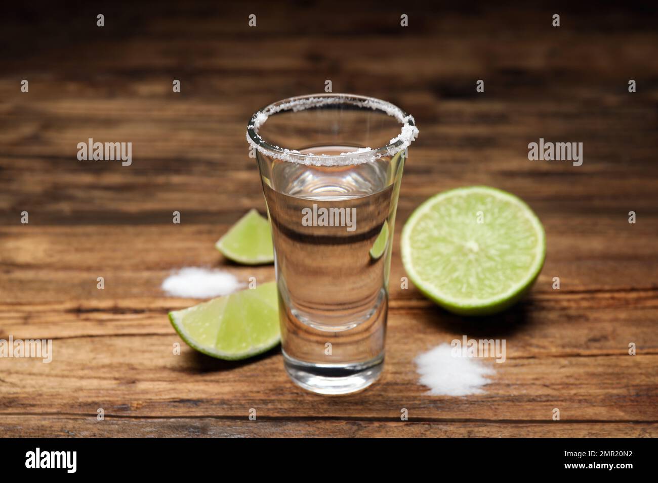 Mexican Tequila shot with salt and lime on wooden table Stock Photo - Alamy