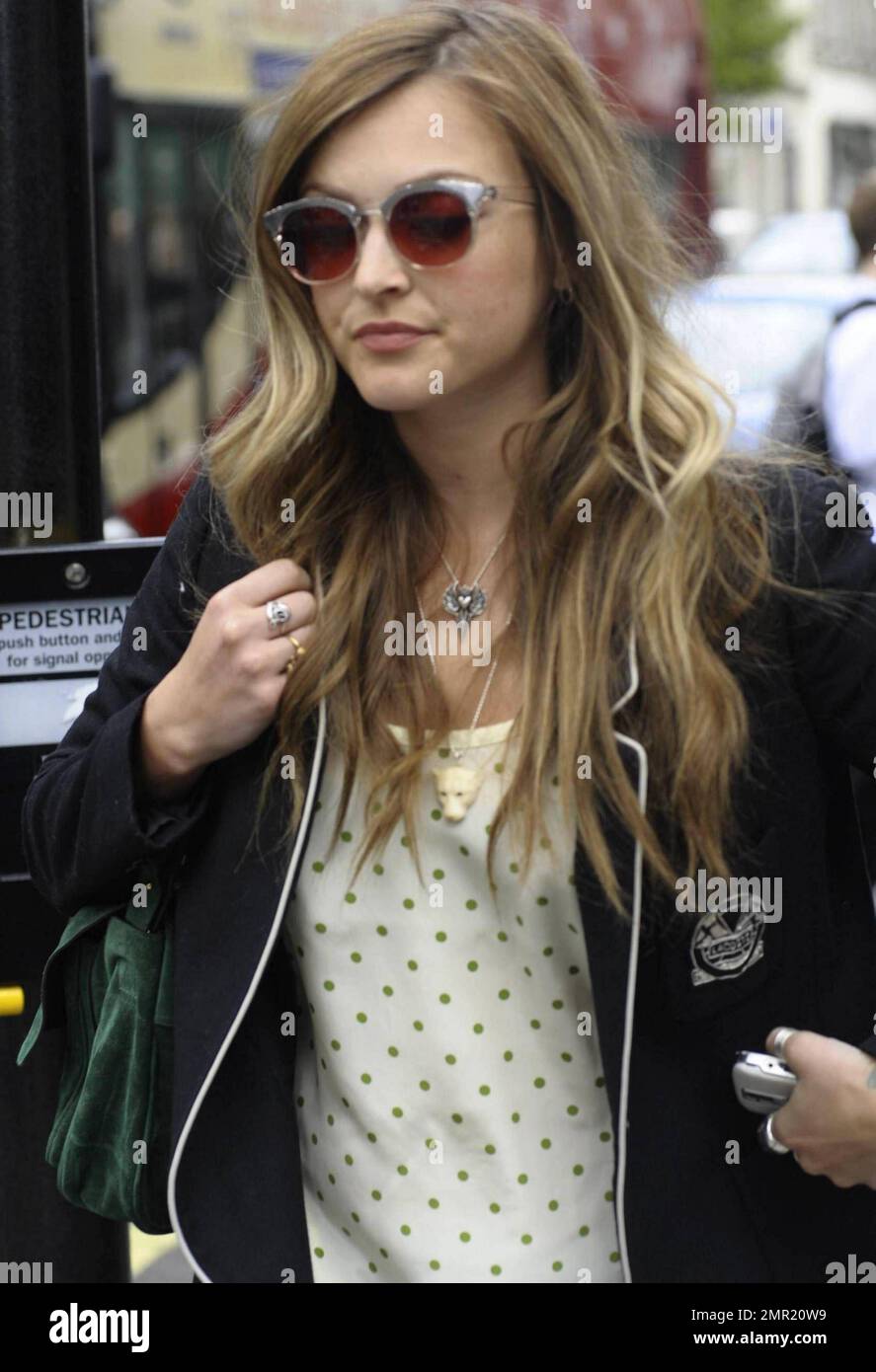 TV and radio personality Fearne Cotton chats on her cellphone as she ...