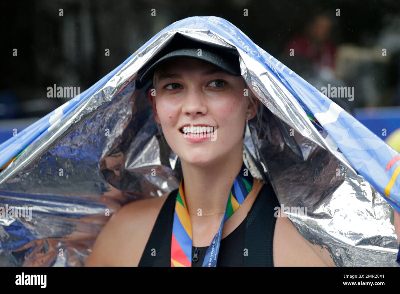 Model Karlie Kloss poses for pictures after crossing the finish line of ...