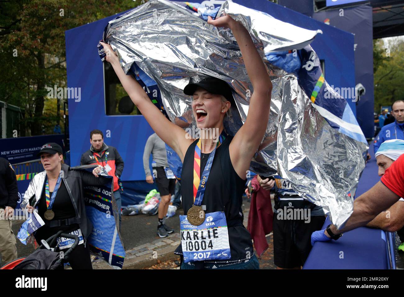 Model Karlie Kloss poses for pictures after crossing the finish line of ...
