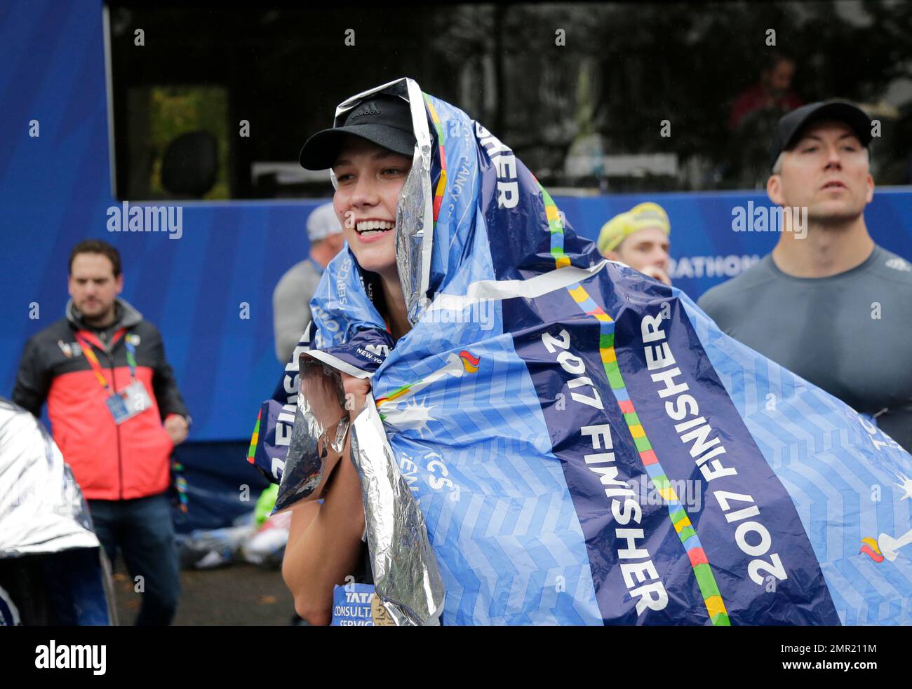 Model Karlie Kloss poses for pictures after crossing the finish line of ...