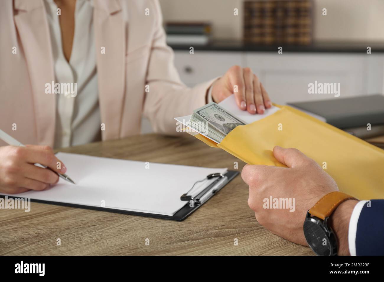 Woman giving envelope bribe hi-res stock photography and images - Alamy