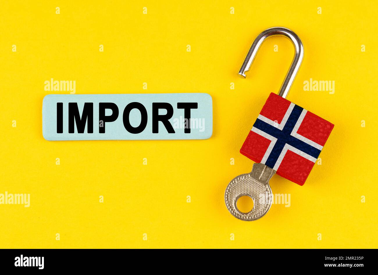 On a yellow surface, an open lock with the image of the flag of Norway ...