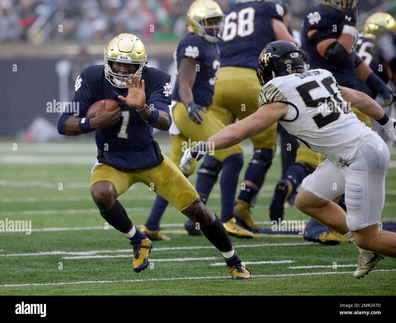 Notre Dame quarterback Brandon Wimbush , left, carries a ball against ...