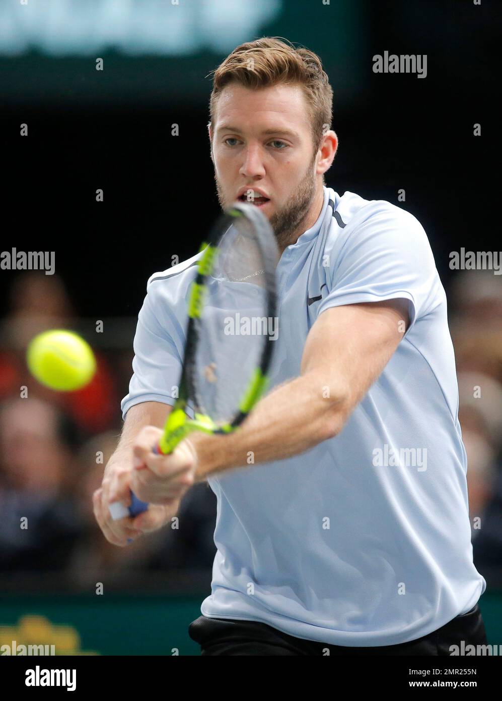 Jack Sock of the United States returns the ball to Filip Krajinovic of ...