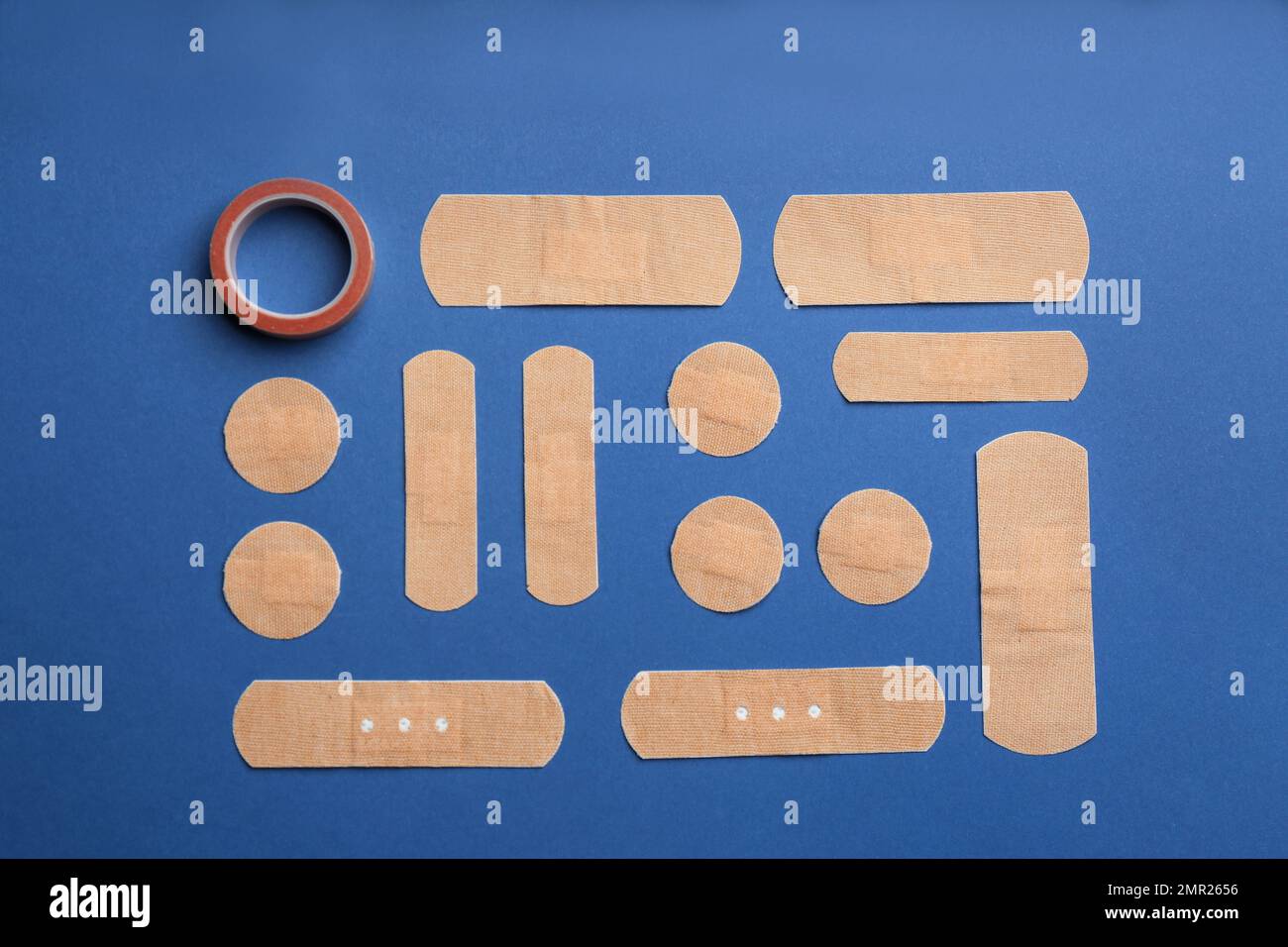 Different types of sticking plasters on blue background, flat lay Stock ...