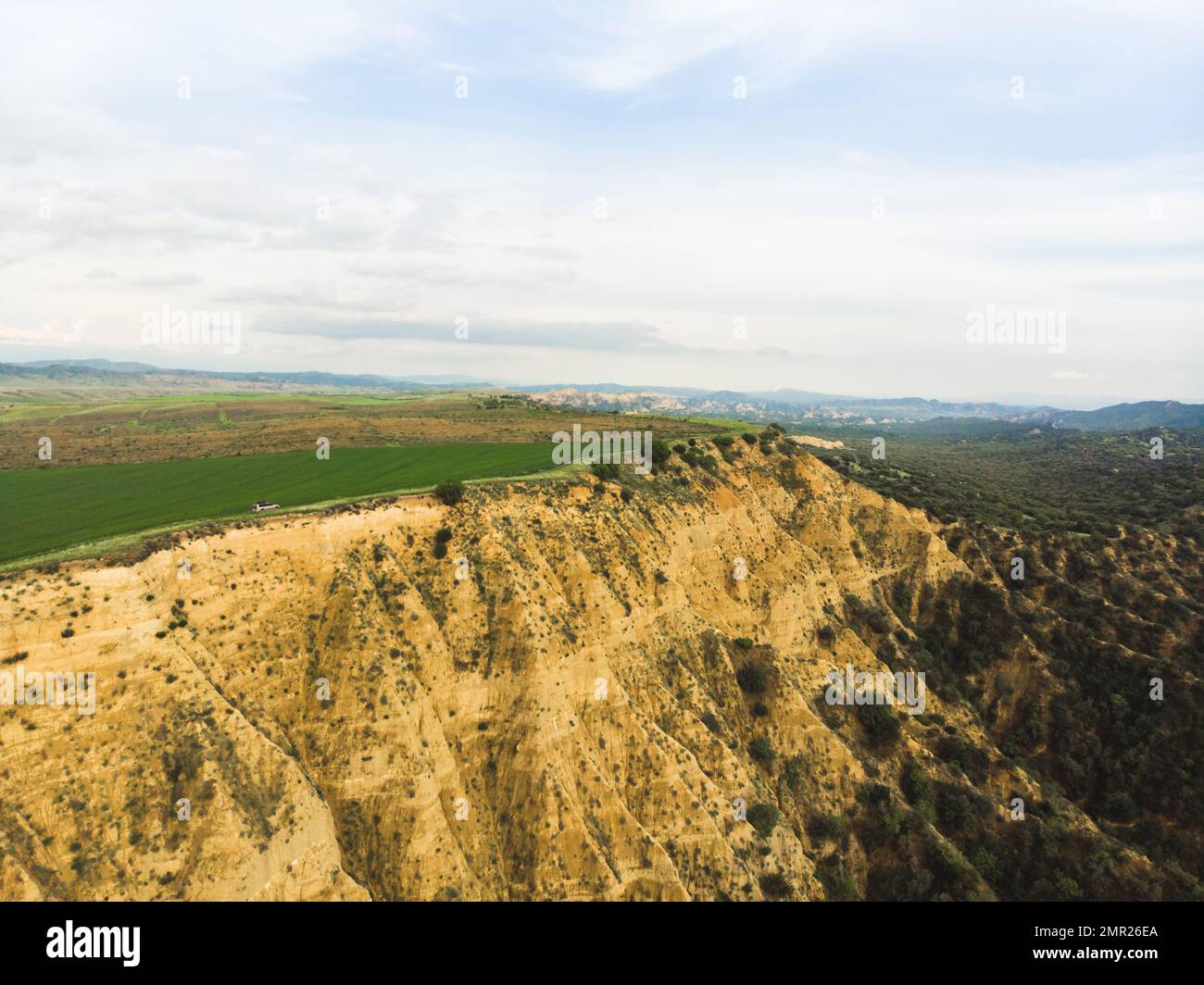 Aerial fly over 4wd tour vehicle driving on famous VAshlovani national ...