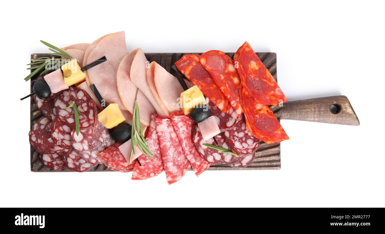 Wooden board with tasty ham and other delicacies isolated on white, top ...