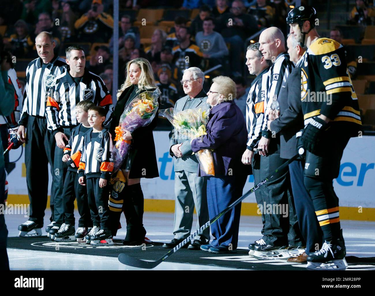 Referee Chris Rooney, second from left, stands on the ice with his two ...
