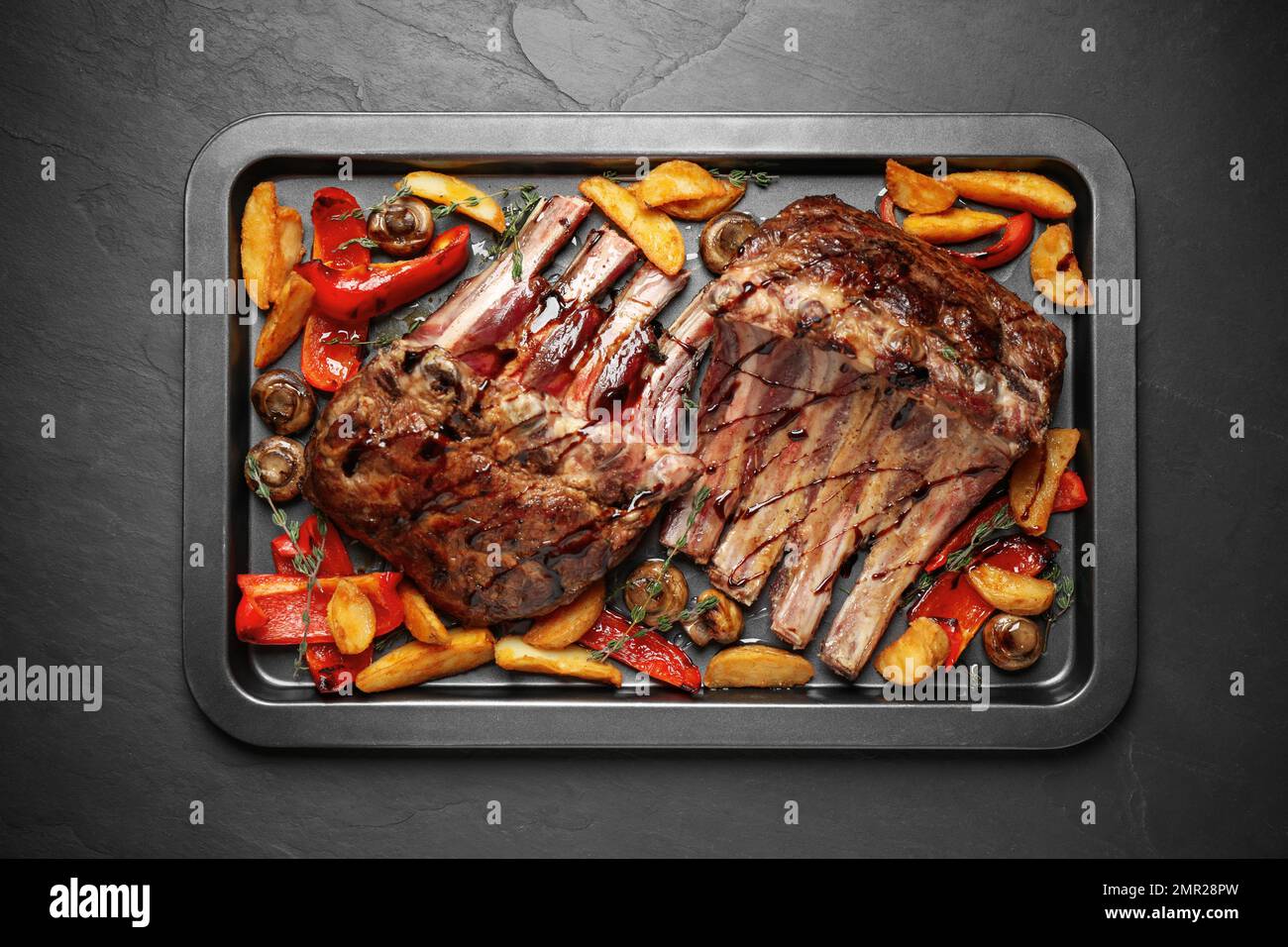 Delicious roasted ribs with garnish, top view Stock Photo - Alamy