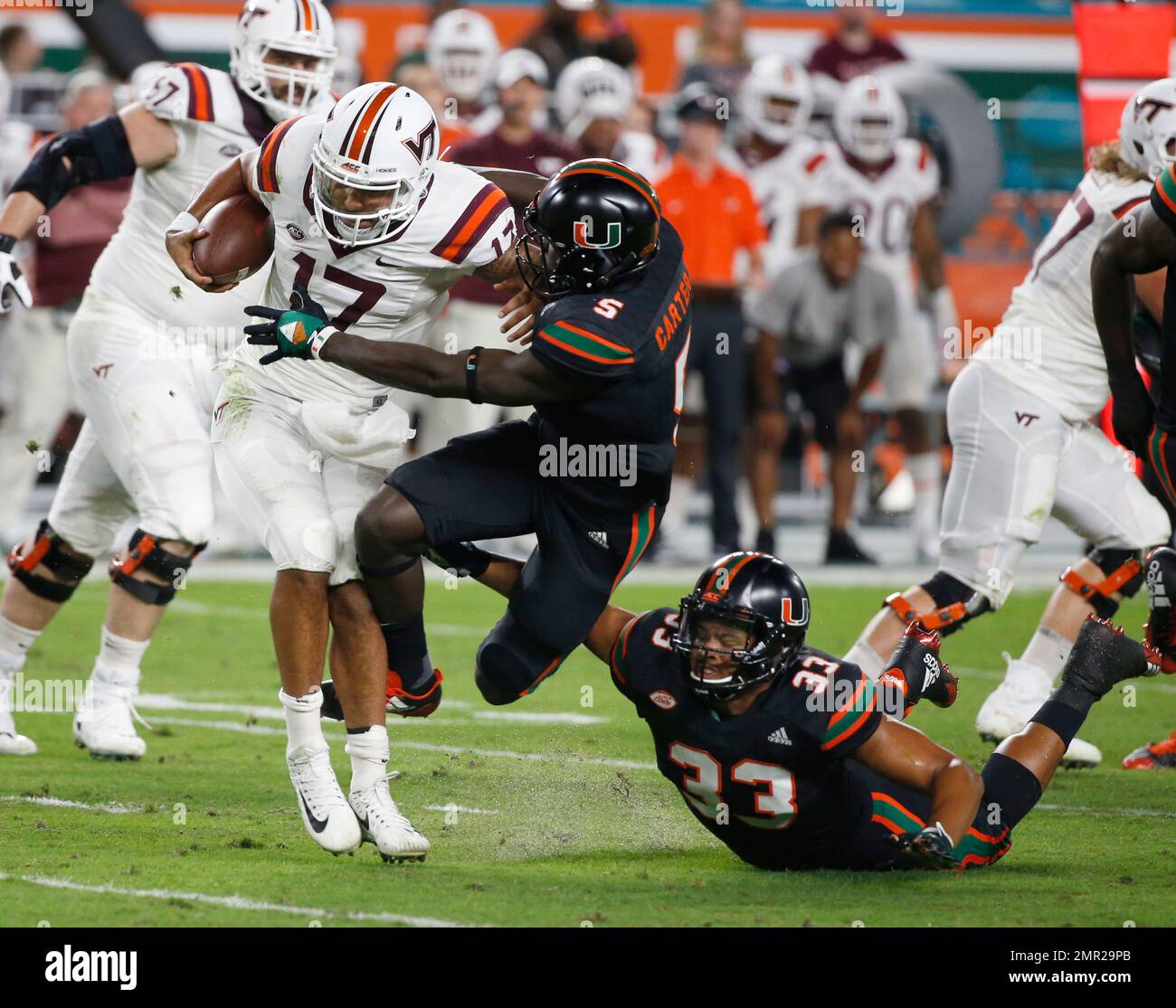 Miami defensive back Amari Carter (5) sacks Virginia Tech quarterback ...