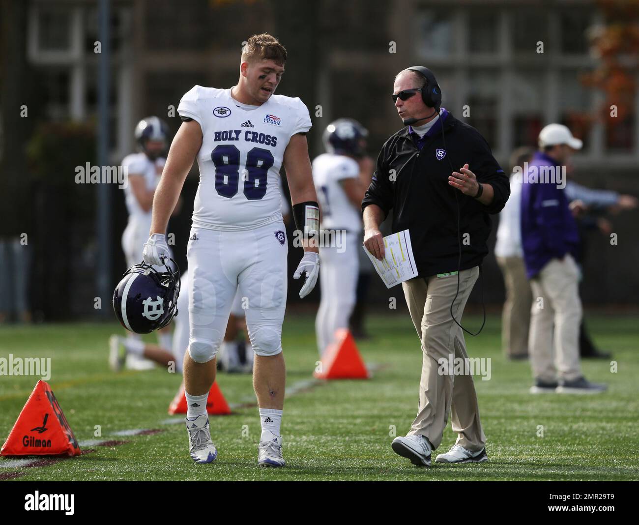 Holy Cross' interim head coach Brian Rock, right, speaks with Jayke ...