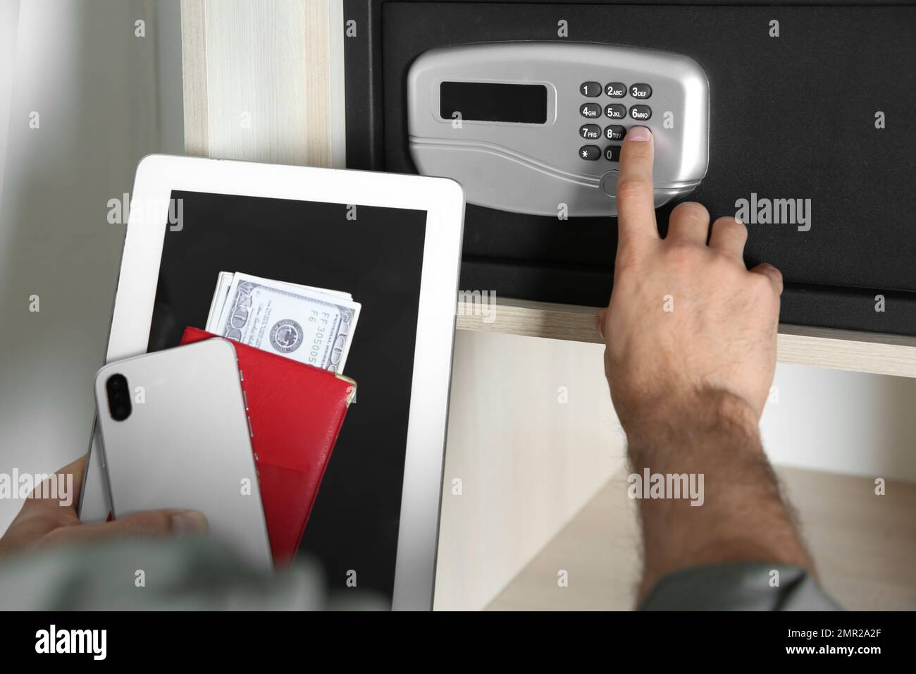 Man opening steel safe with electronic lock at hotel, closeup Stock ...