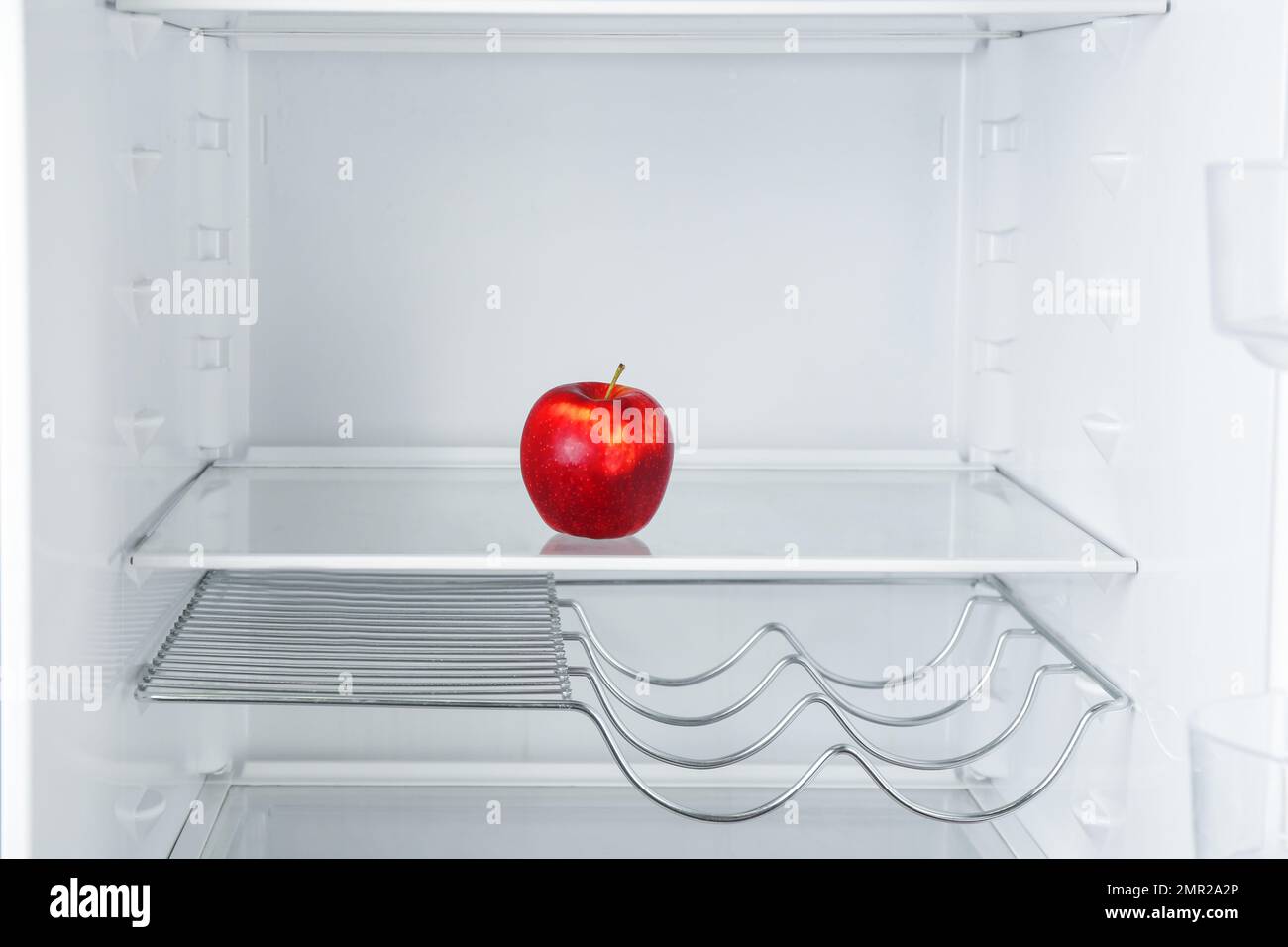Fresh red apple on empty shelf in refrigerator Stock Photo - Alamy