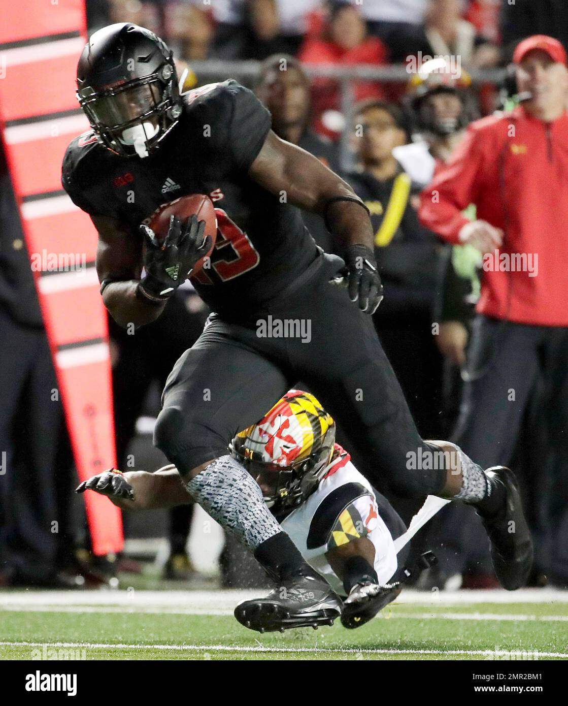 Rutgers running back Gus Edwards, front, avoids a tackle by Maryland ...