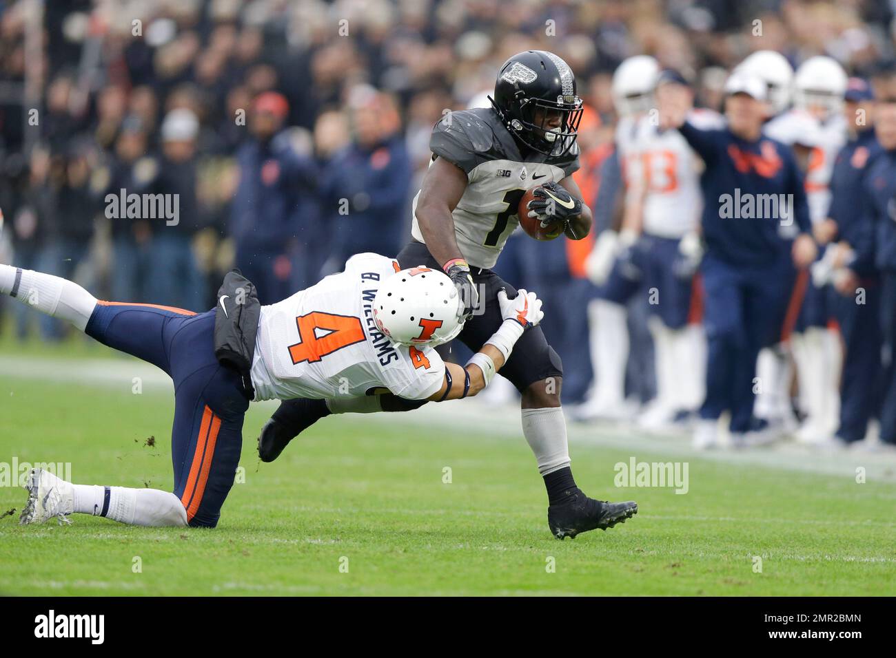 Illinois defensive back Bennett Williams (4) tackles Purdue running ...
