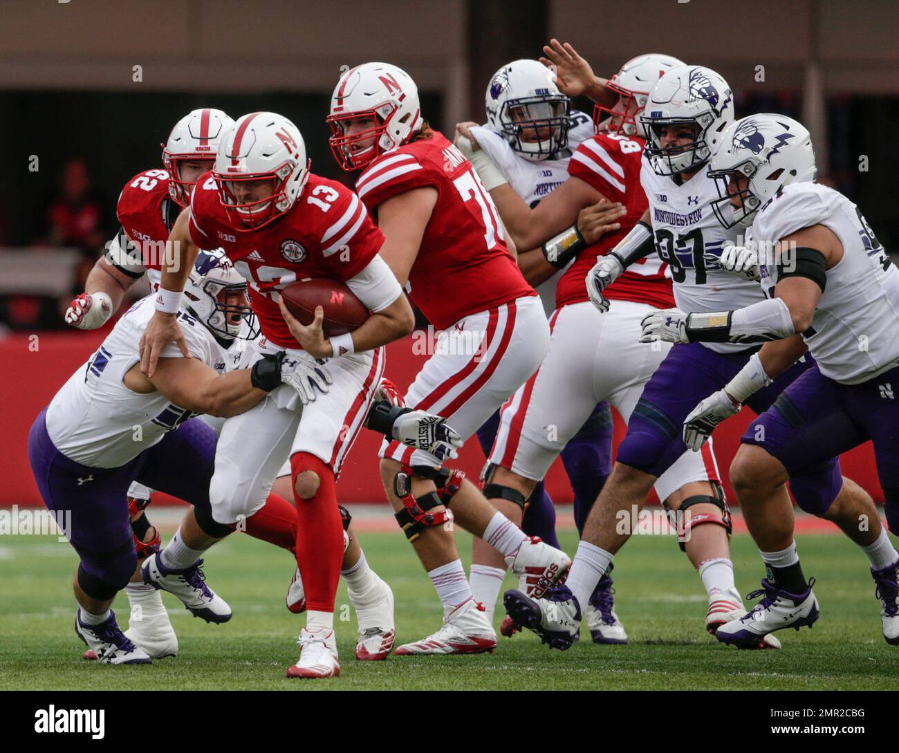 Northwestern defensive lineman Alex Miller, left, tackles Nebraska ...