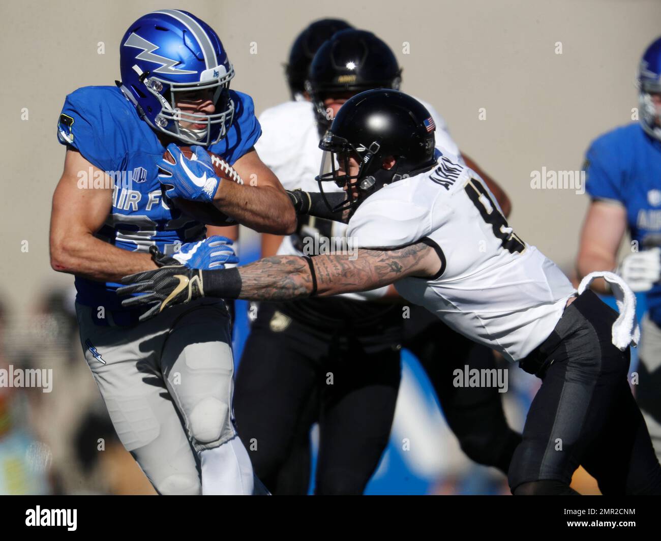 Air Force running back Timothy McVey, left, is tackled after a short ...