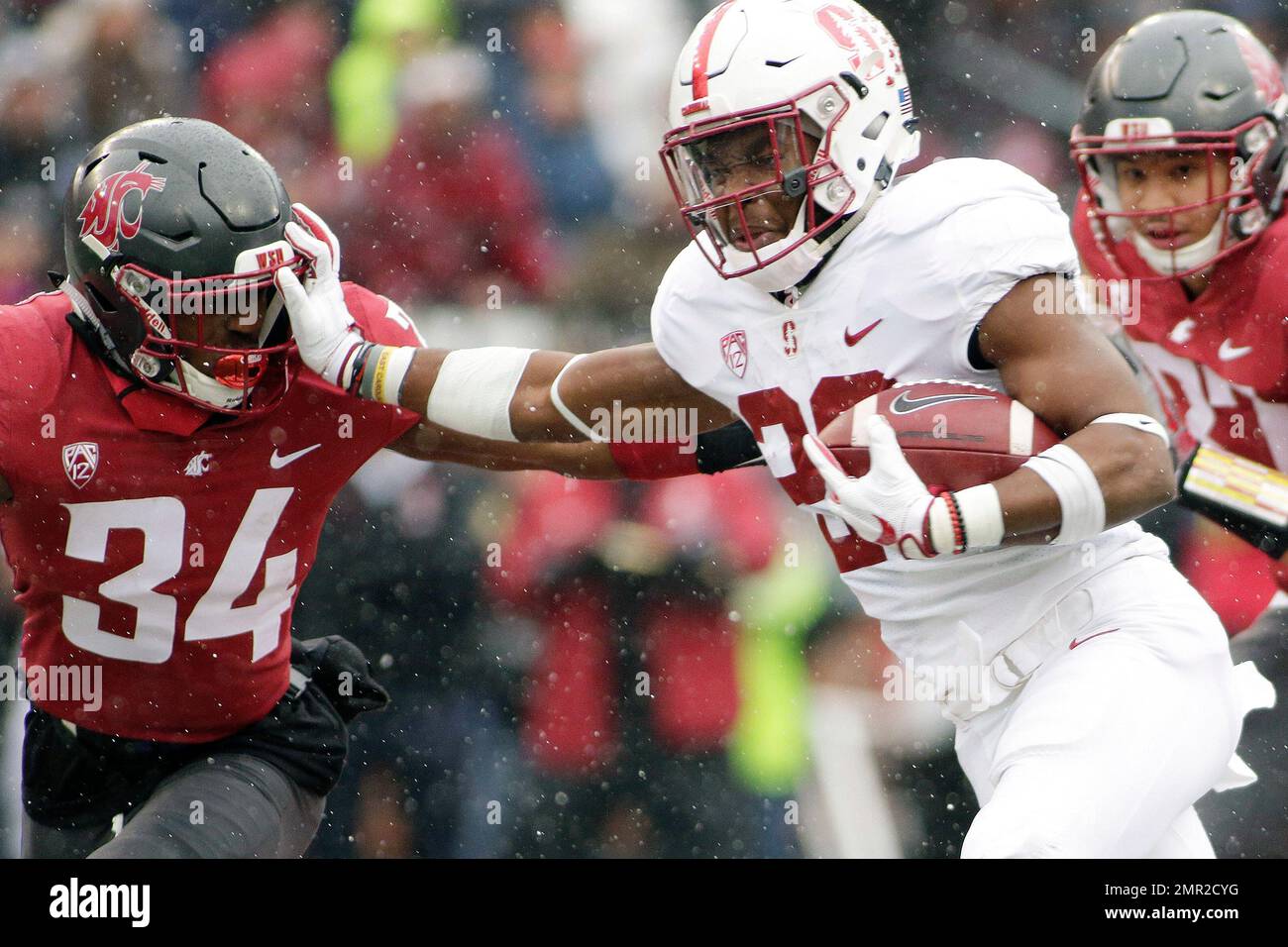 Stanford running back Bryce Love, right, stiff arms Washington State ...