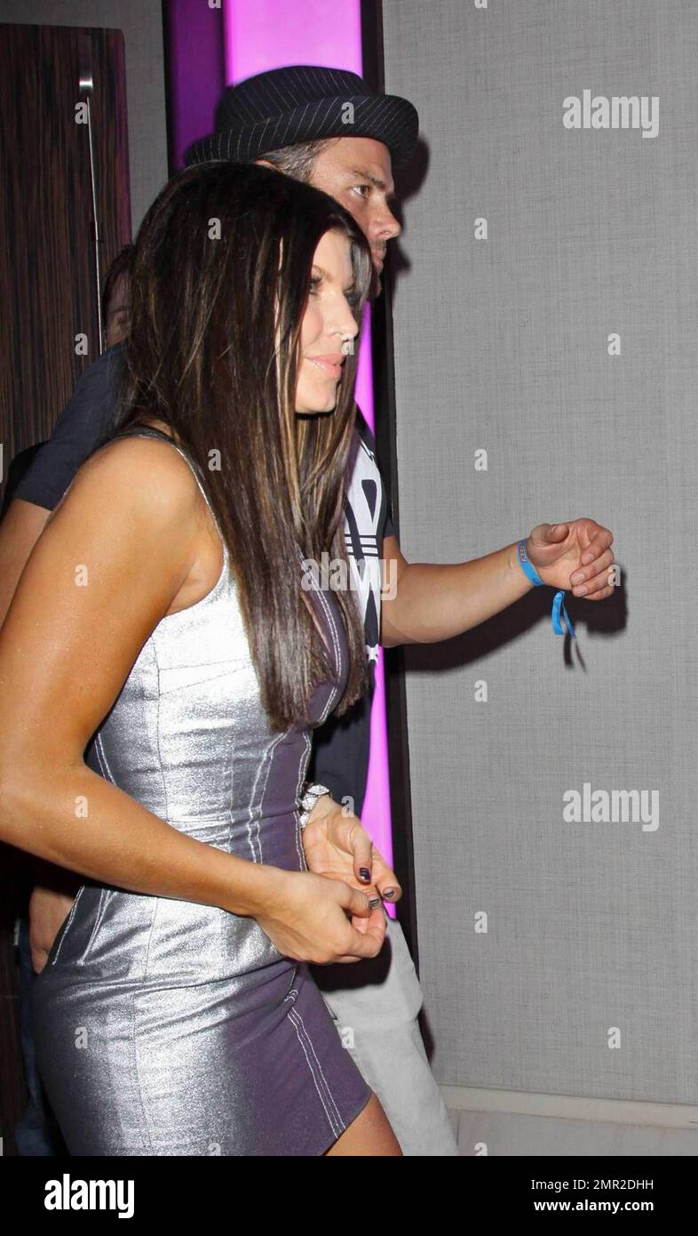 Fergie looks amazing in a skin tight silver mini dress and heels as ...