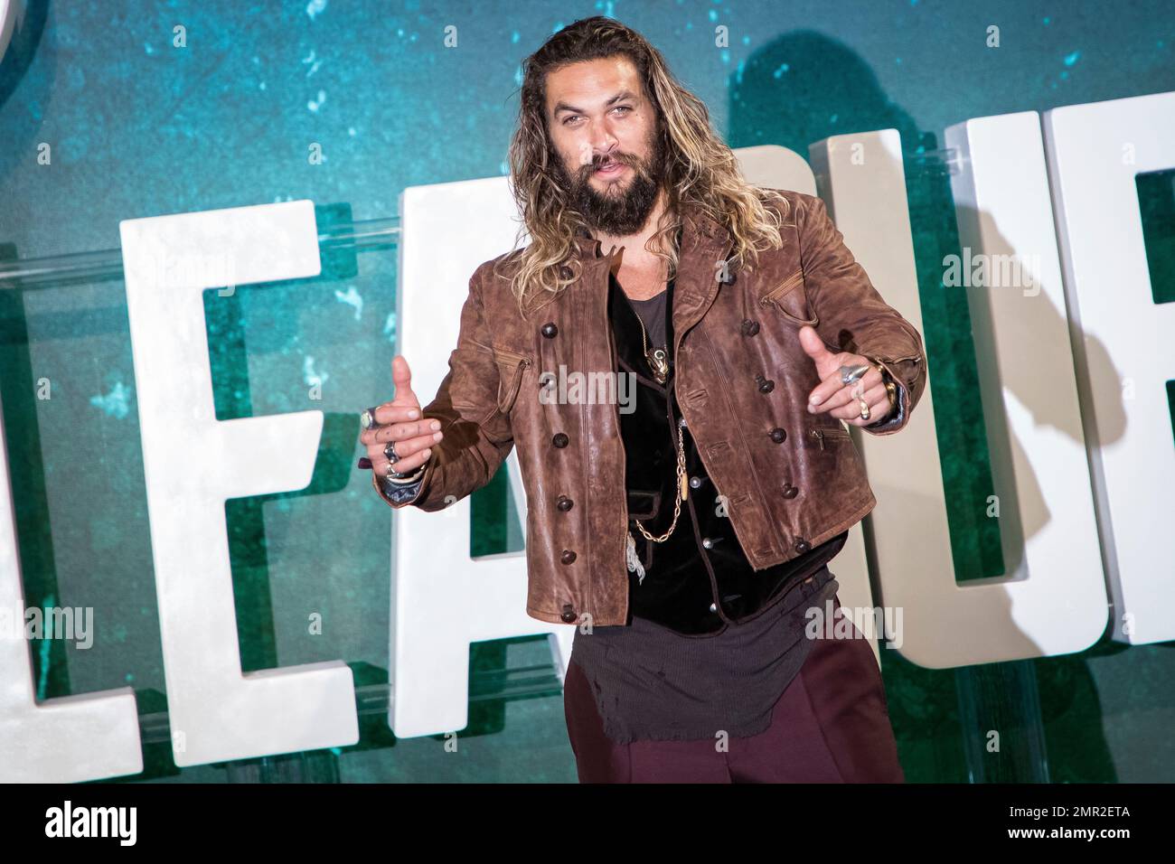 Actor Jason Momoa poses for photographers upon arrival at a photo call ...
