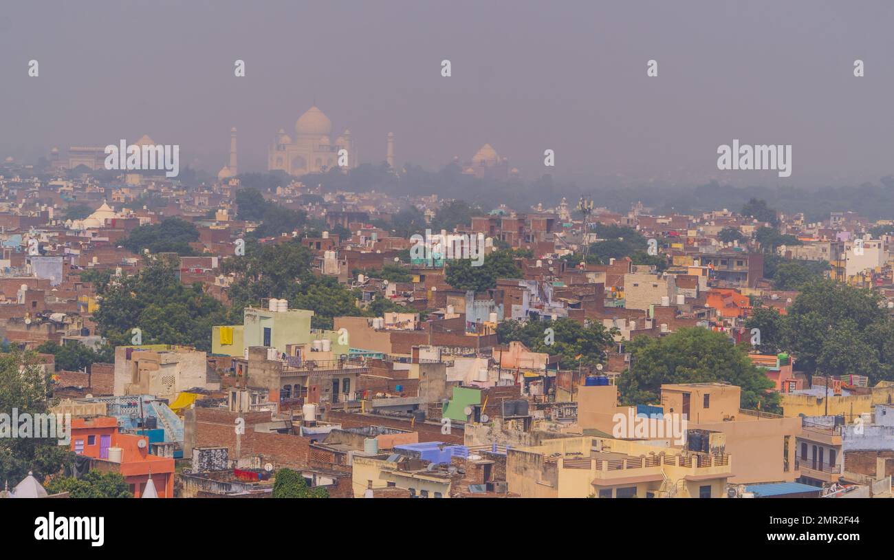 An aerial shot of the cityscape of the central Agra in smog with Taj ...