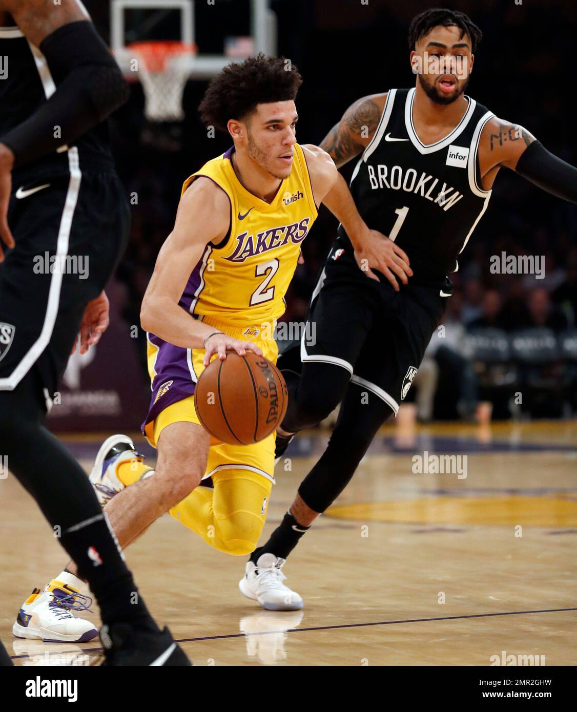 Los Angeles Lakers guard Lonzo Ball, left, dribbles to the basket past ...