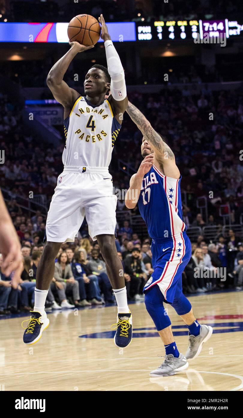 Indiana Pacers' Victor Oladipo, left, shoots as Philadelphia 76ers' JJ ...