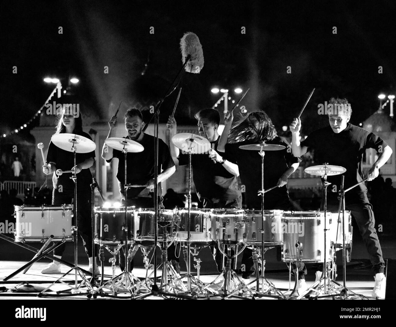 A black and white view of a band with young musicians playing drums in ...