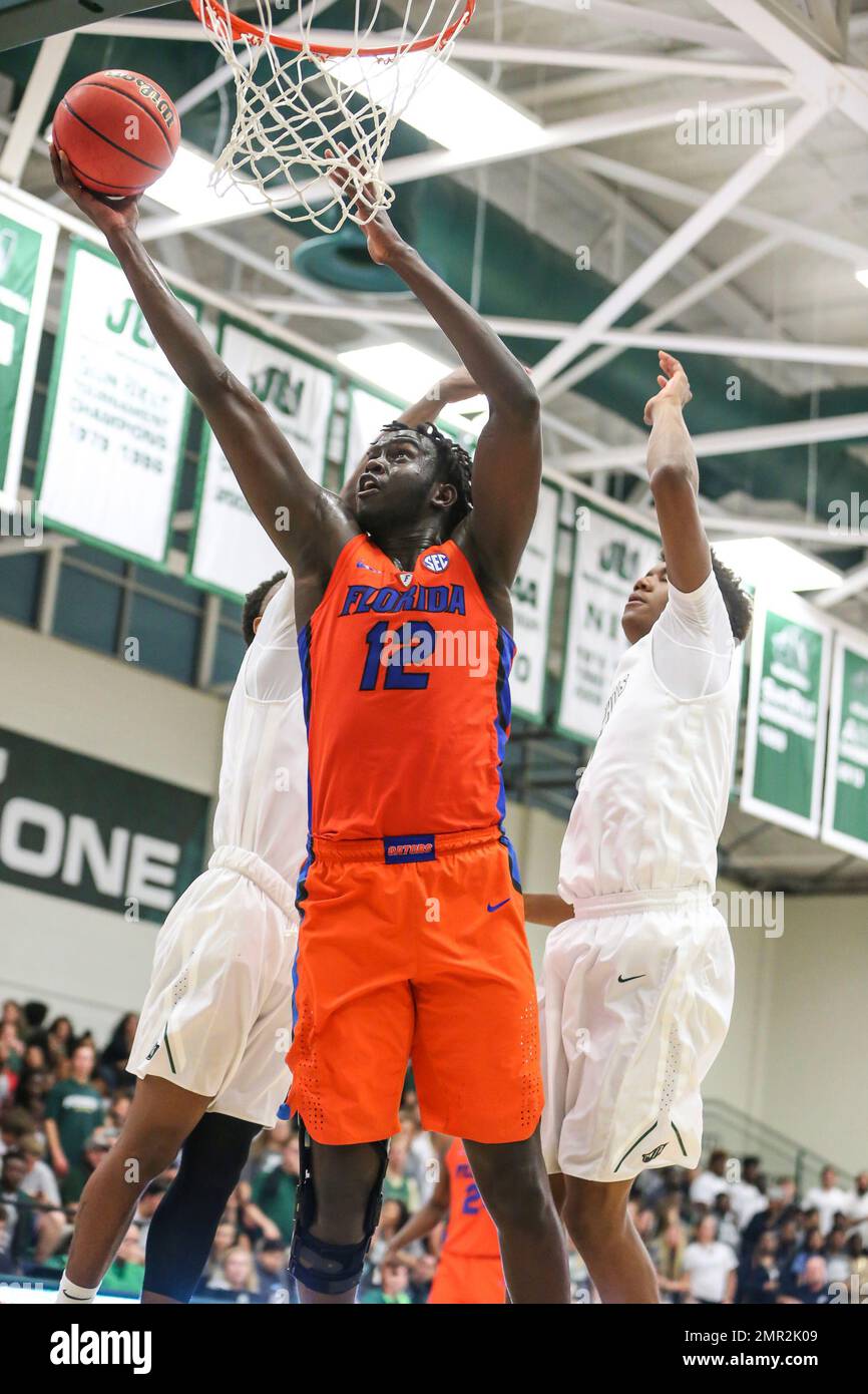 Florida center Gorjok Gak (12) lays the ball to the basket during the second half of an NCAA men ...