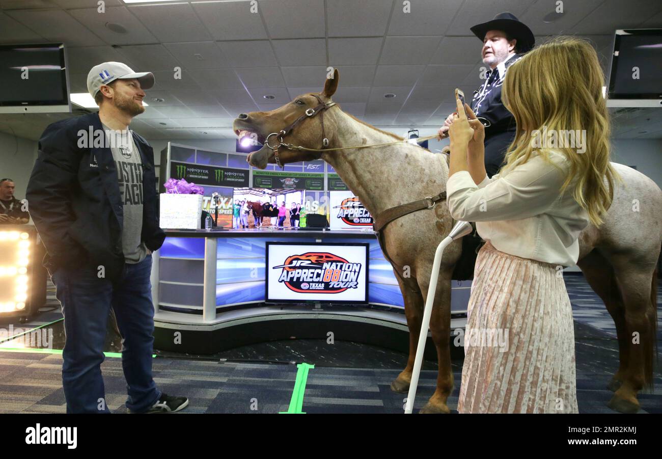 Dale Earnhardt Jr., left, looks on as Eddie Gossage, president and CEO ...