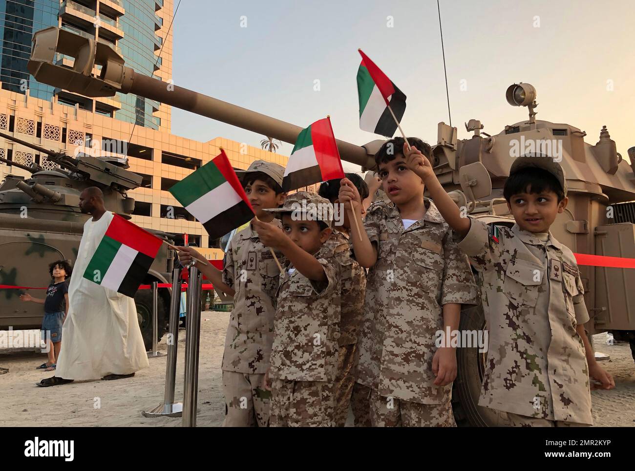 Emirati boys wave their national flag during a military exercise in ...
