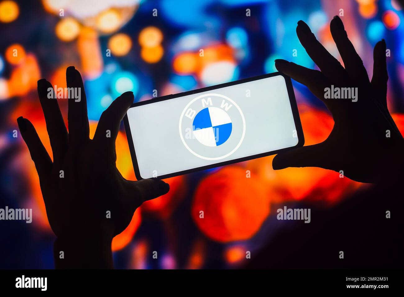 In this photo illustration, the BMW logo is displayed on a smartphone ...