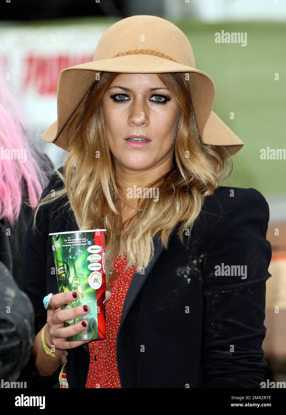 Caroline Flack poses for photos while attending the Glastonbury Music ...
