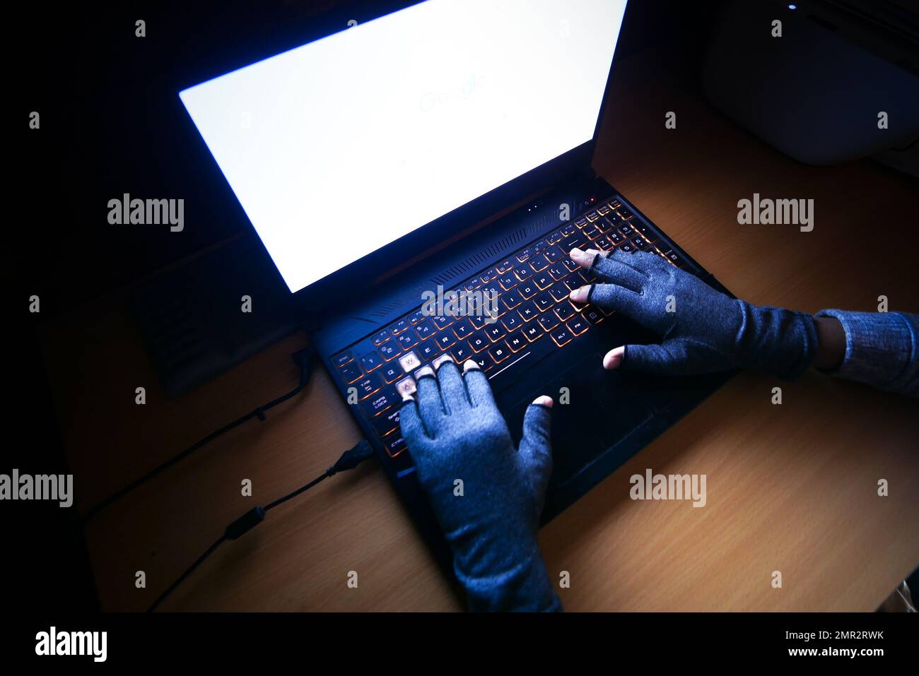 hacker hand stealing data from laptop top down Stock Photo - Alamy