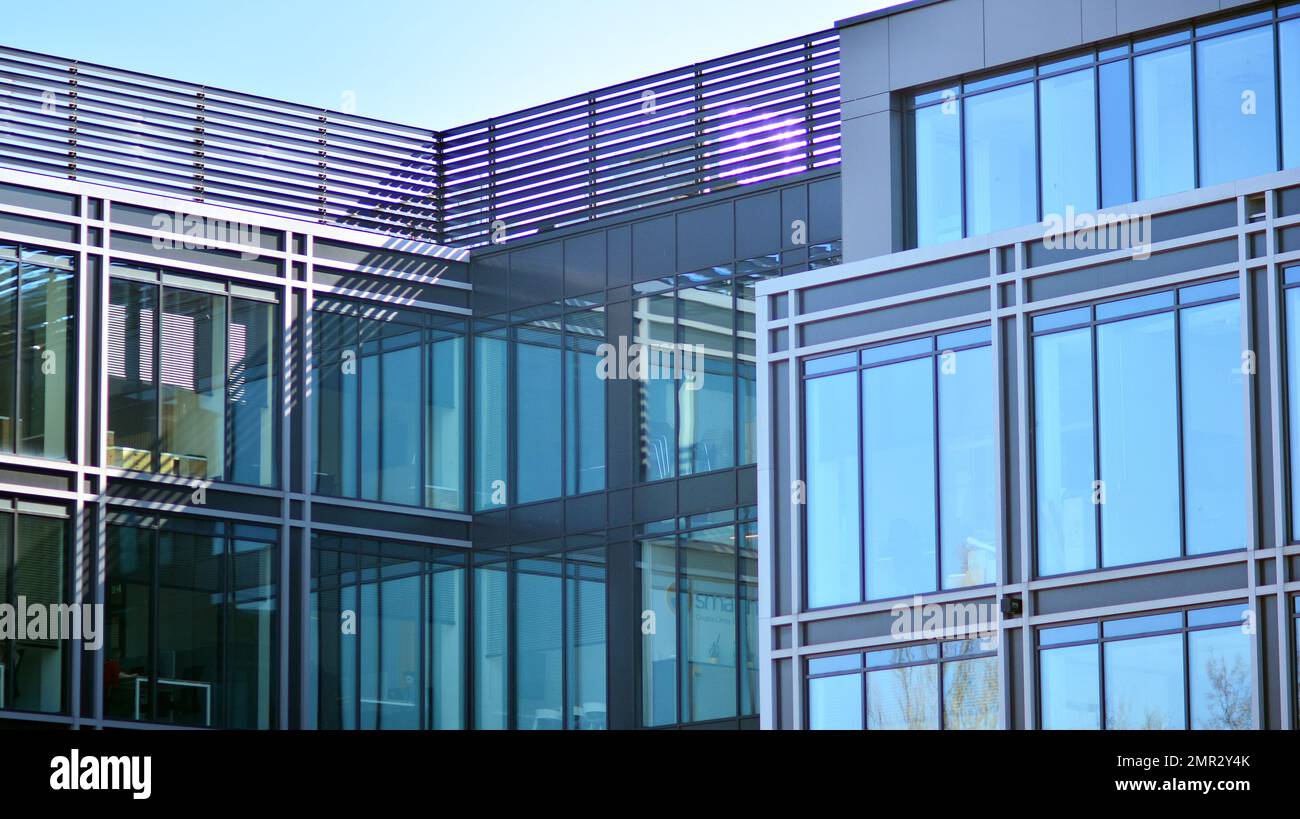 Abstract closeup of the glass-clad facade of a modern building covered ...