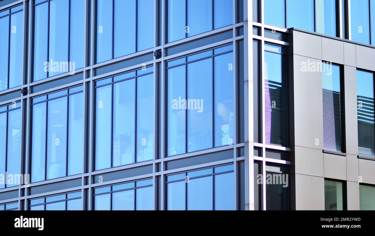 Abstract closeup of the glass-clad facade of a modern building covered ...